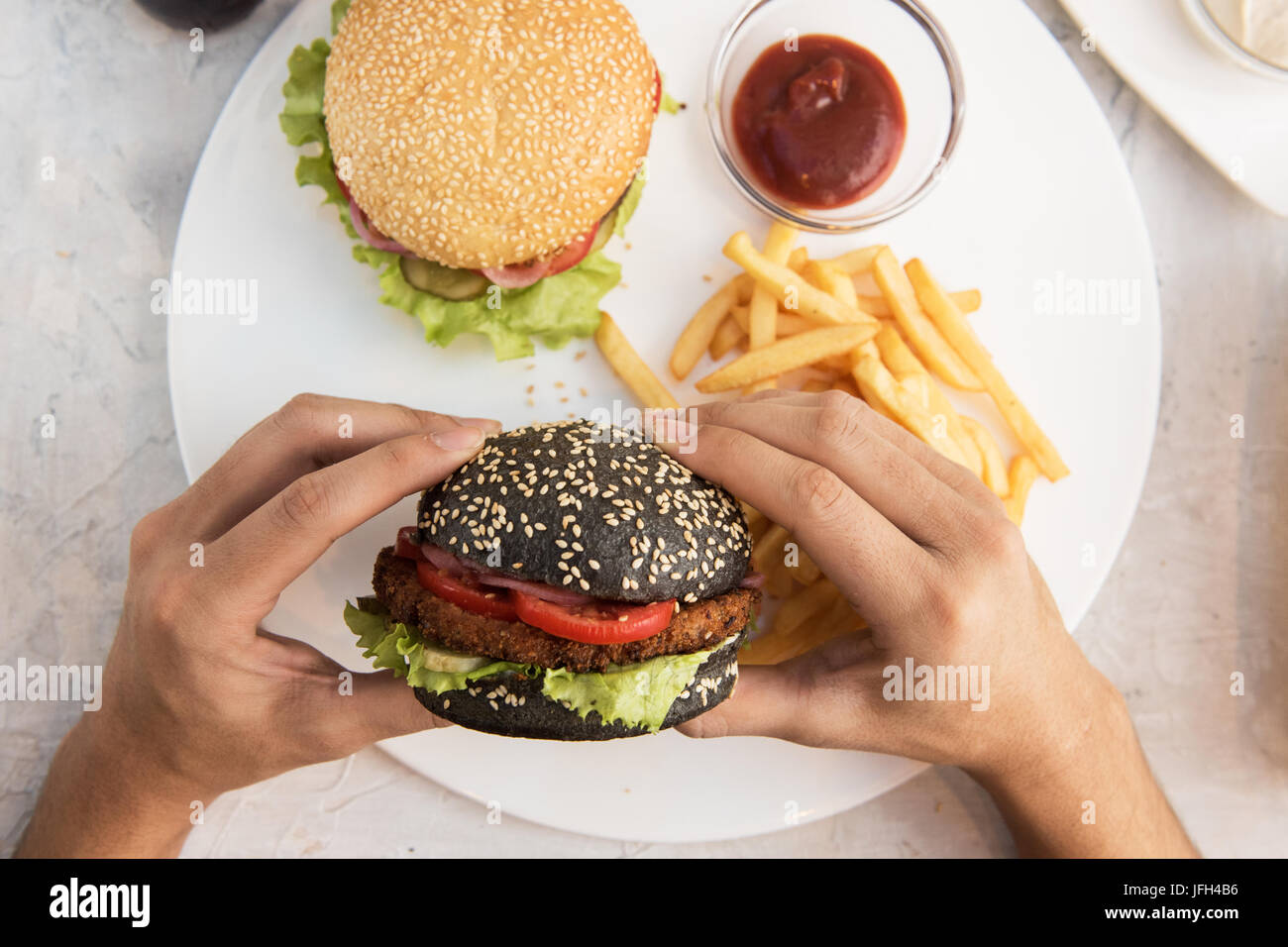Man eating burgers Stock Photo - Alamy