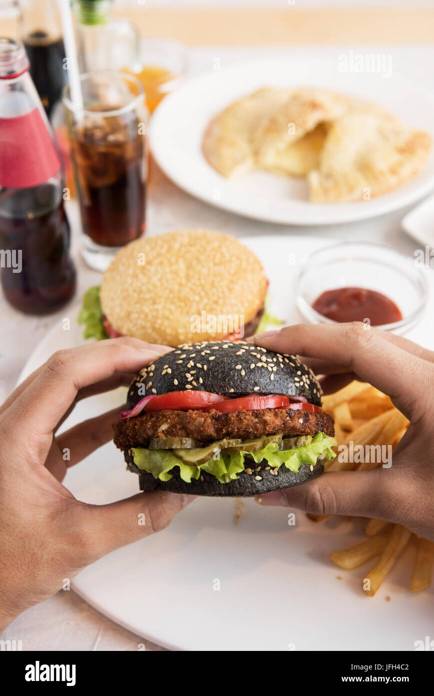 Man eating burgers Stock Photo - Alamy