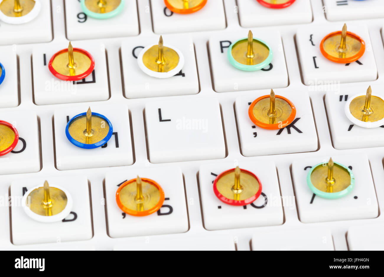 Pins on computer keyboard Stock Photo - Alamy