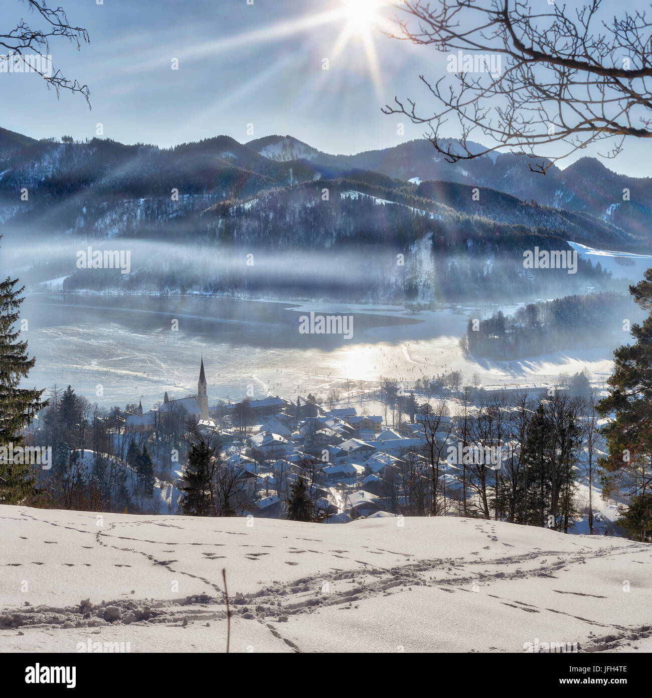 Snow covered town and mountain during sunrise Stock Photo - Alamy