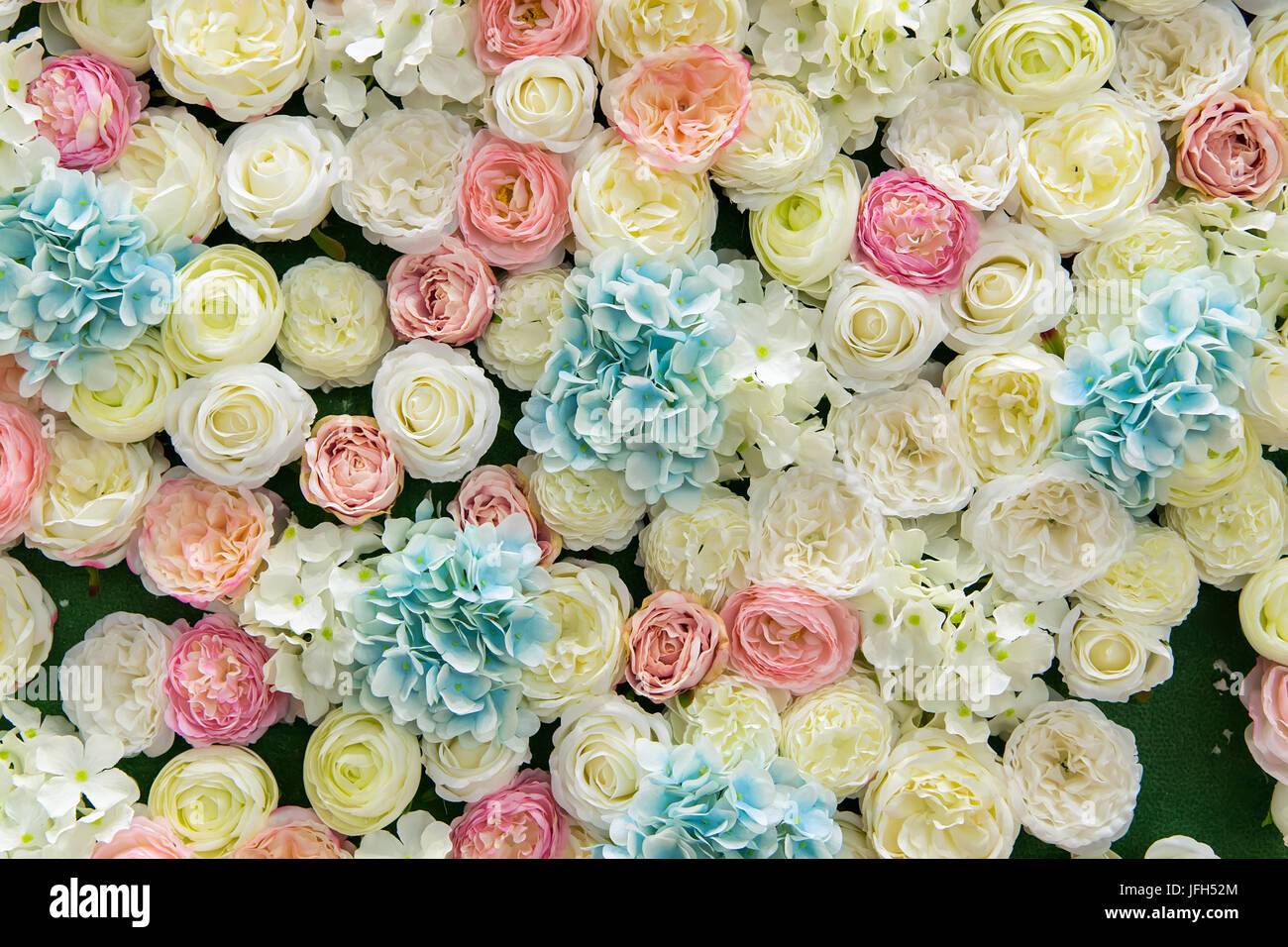 Beautiful multicolored artificial flowers background. flowers decor ...