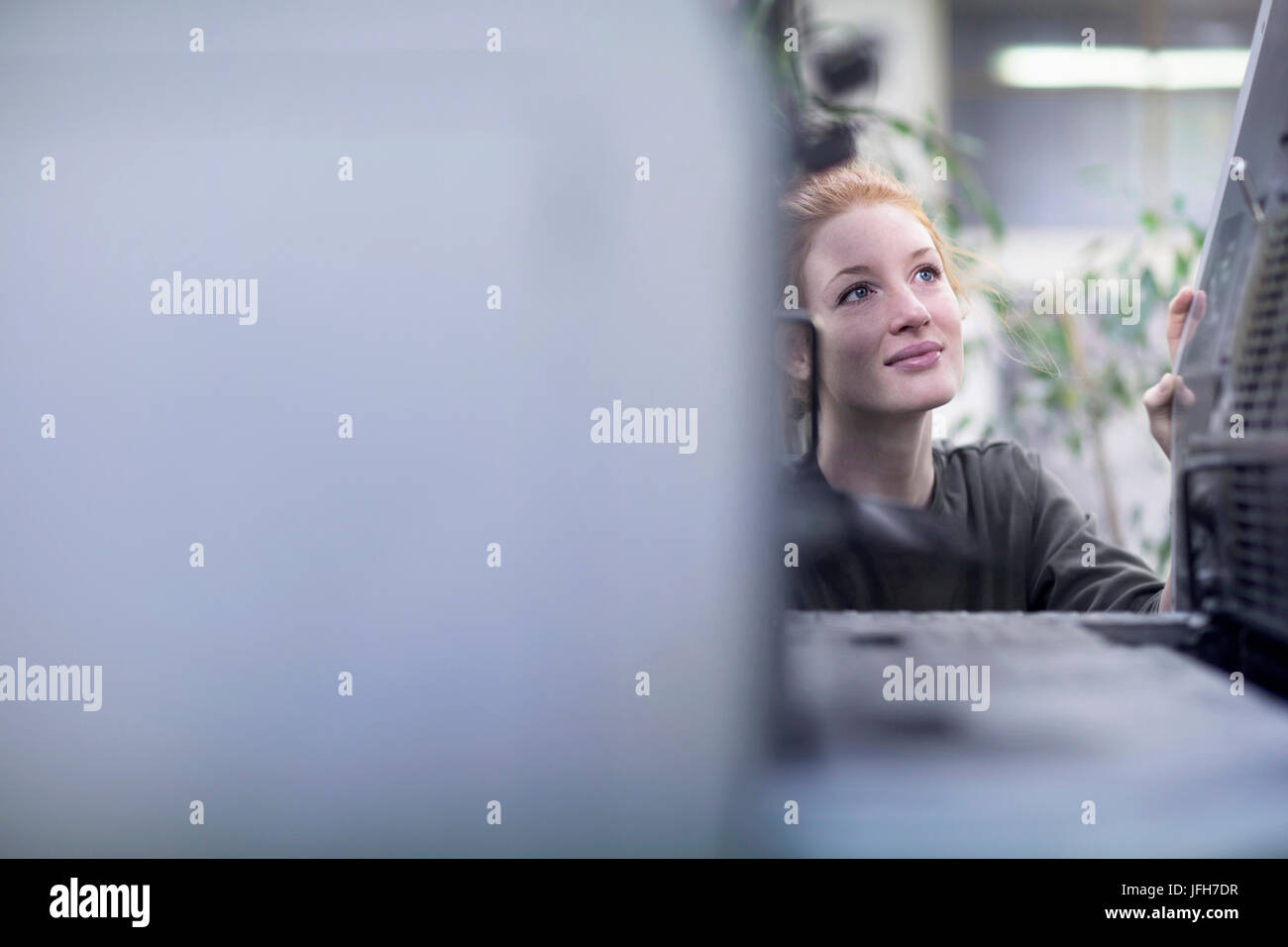 Print worker looking at print machine Stock Photo - Alamy