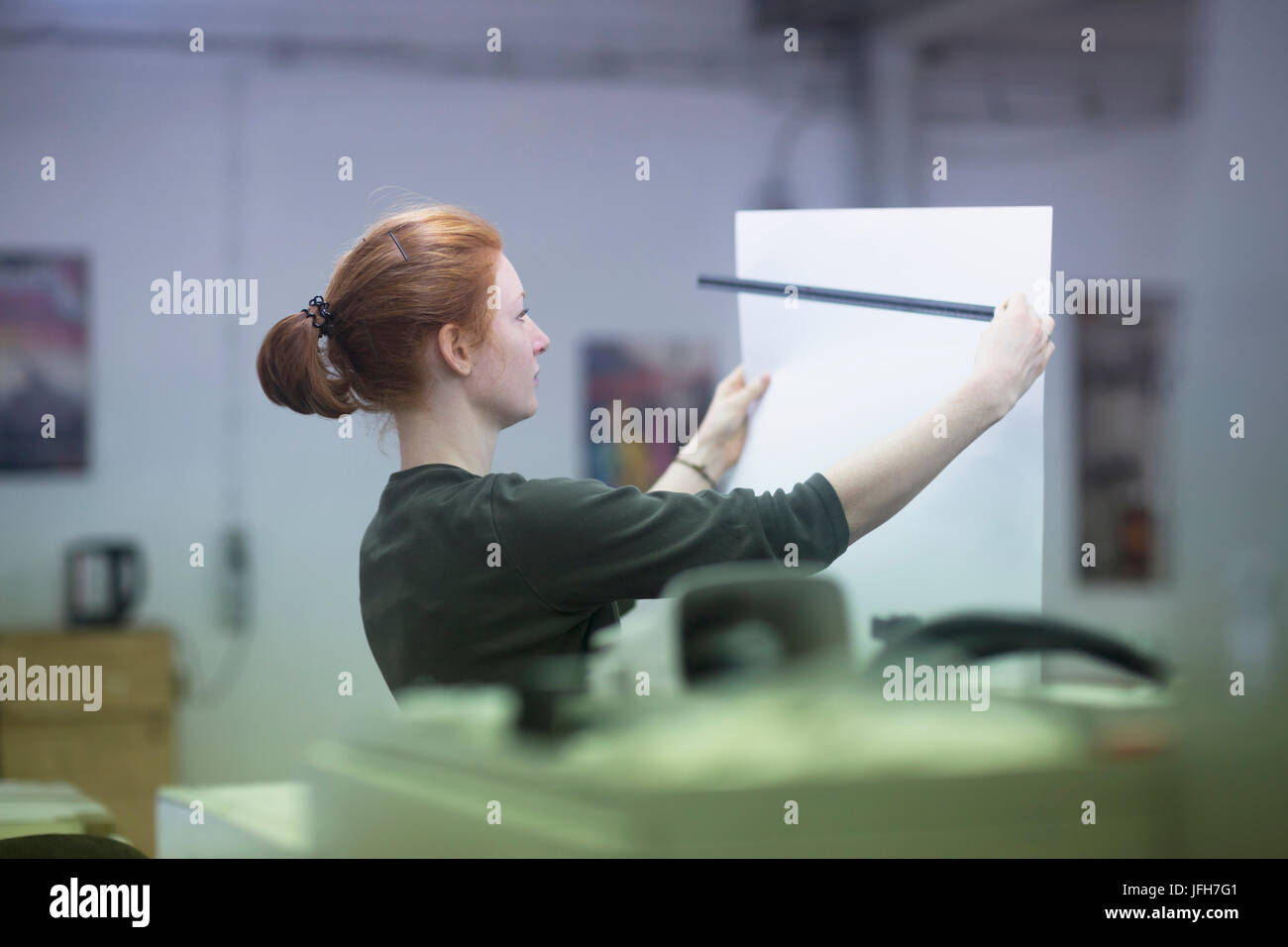 Female print worker measuring paper using ruler Stock Photo - Alamy