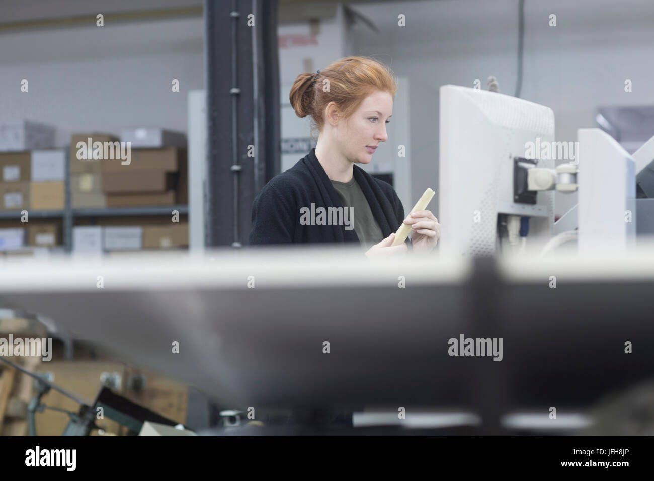 Print worker working by printing equipment at press Stock Photo - Alamy
