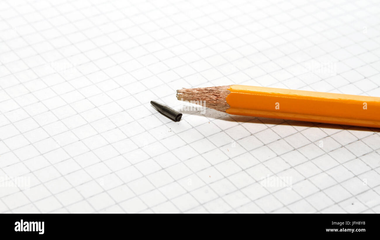 Broken pencil on checkered paper Stock Photo - Alamy