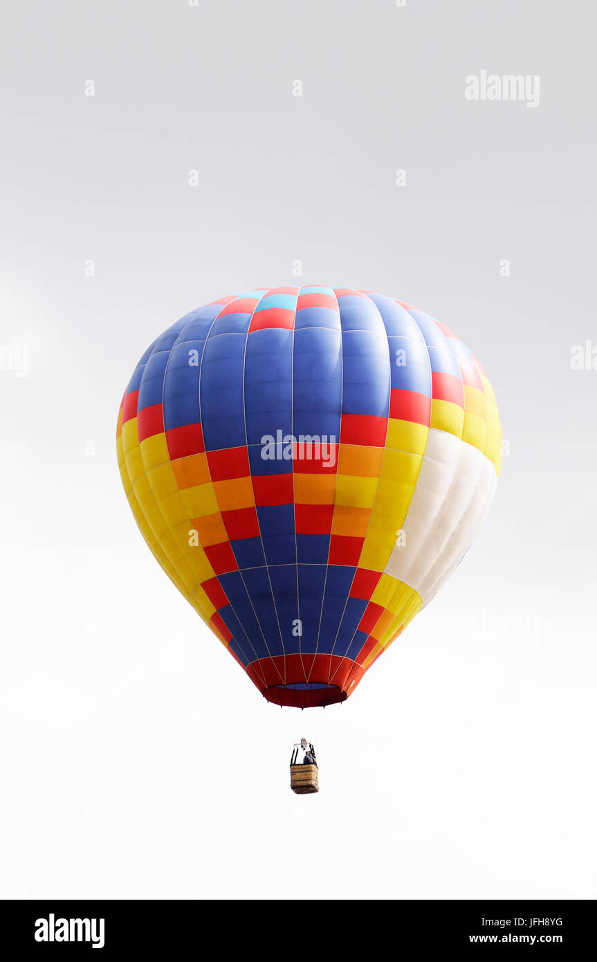 Colored balloon flying in summer grey sky Stock Photo - Alamy