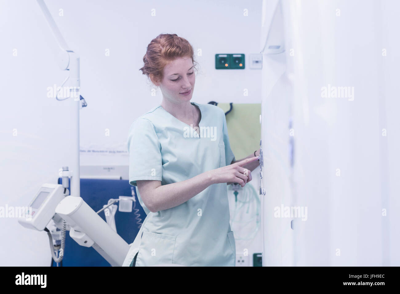 Female nurse operating X-ray machine Stock Photo - Alamy
