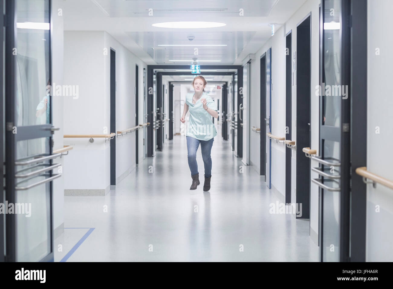 Nurse running in hospital hallway Stock Photo - Alamy