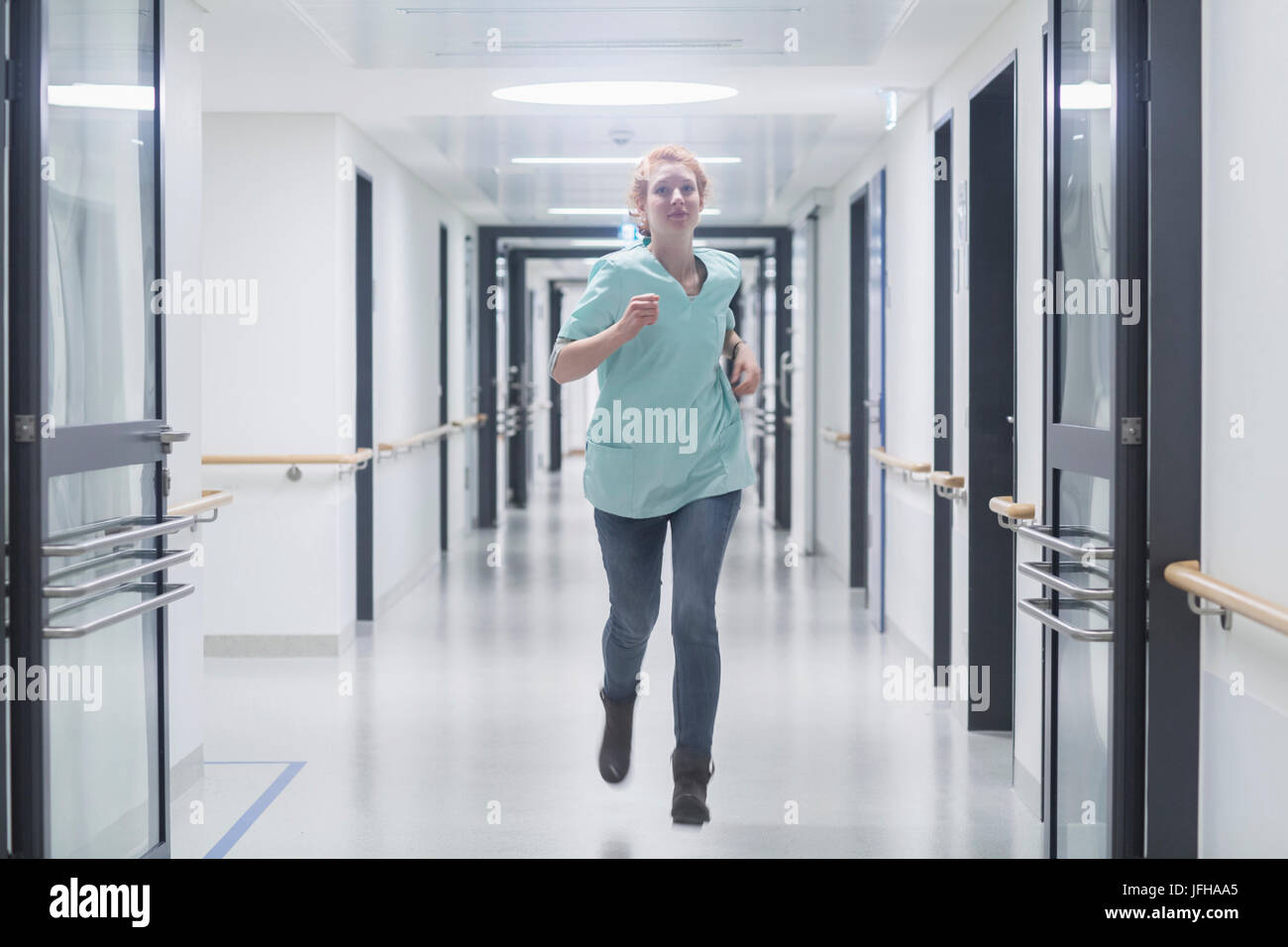 Female nurse running in hospital hallway Stock Photo - Alamy