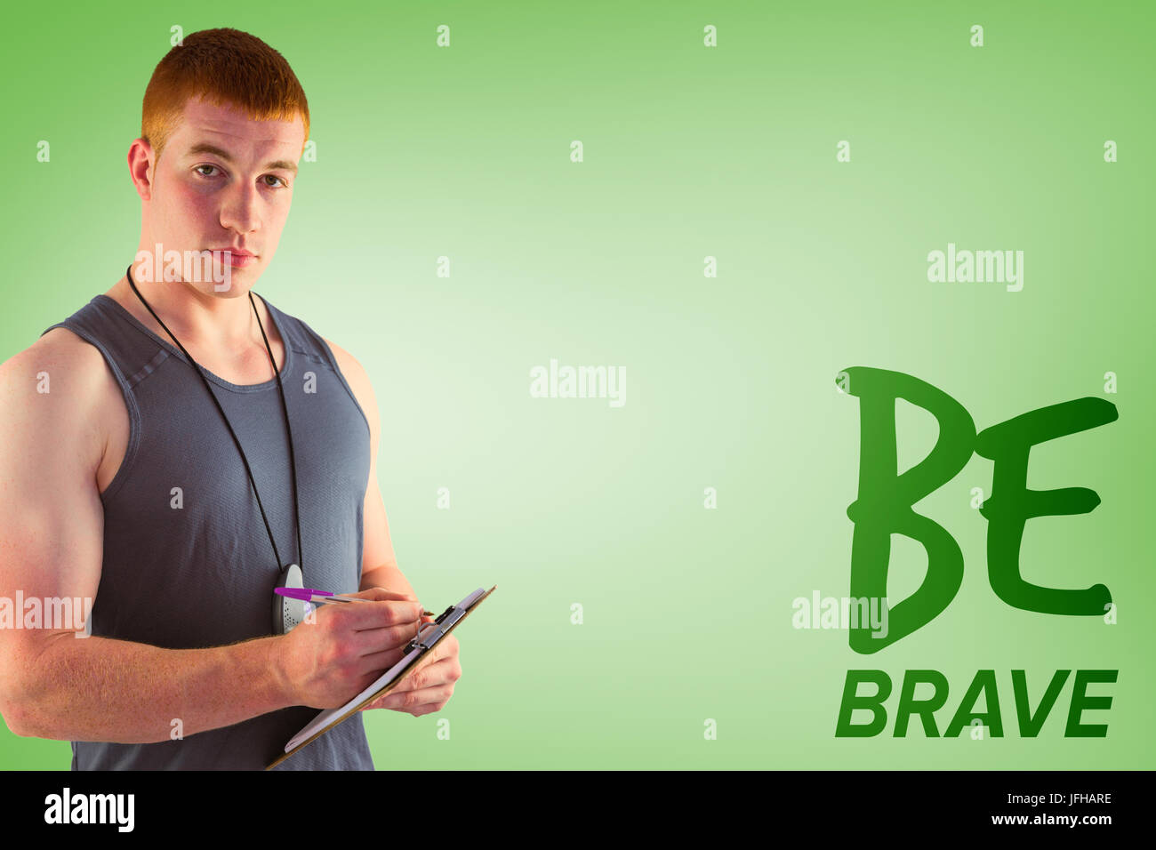 Composite image of fit personal trainer writing on clipboard Stock ...