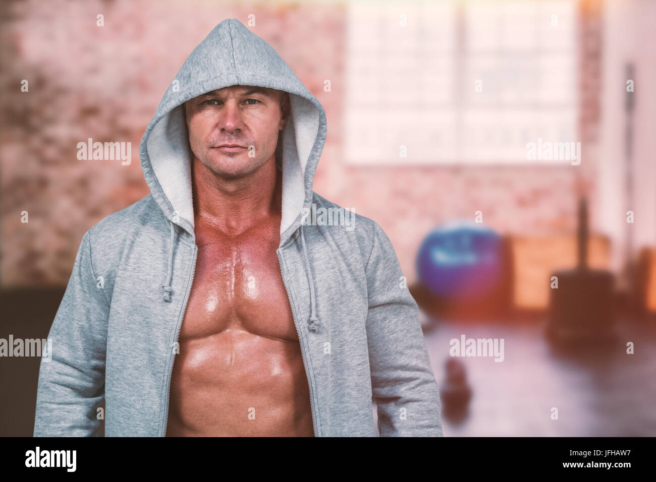 Composite image of portrait of macho man in hood Stock Photo - Alamy