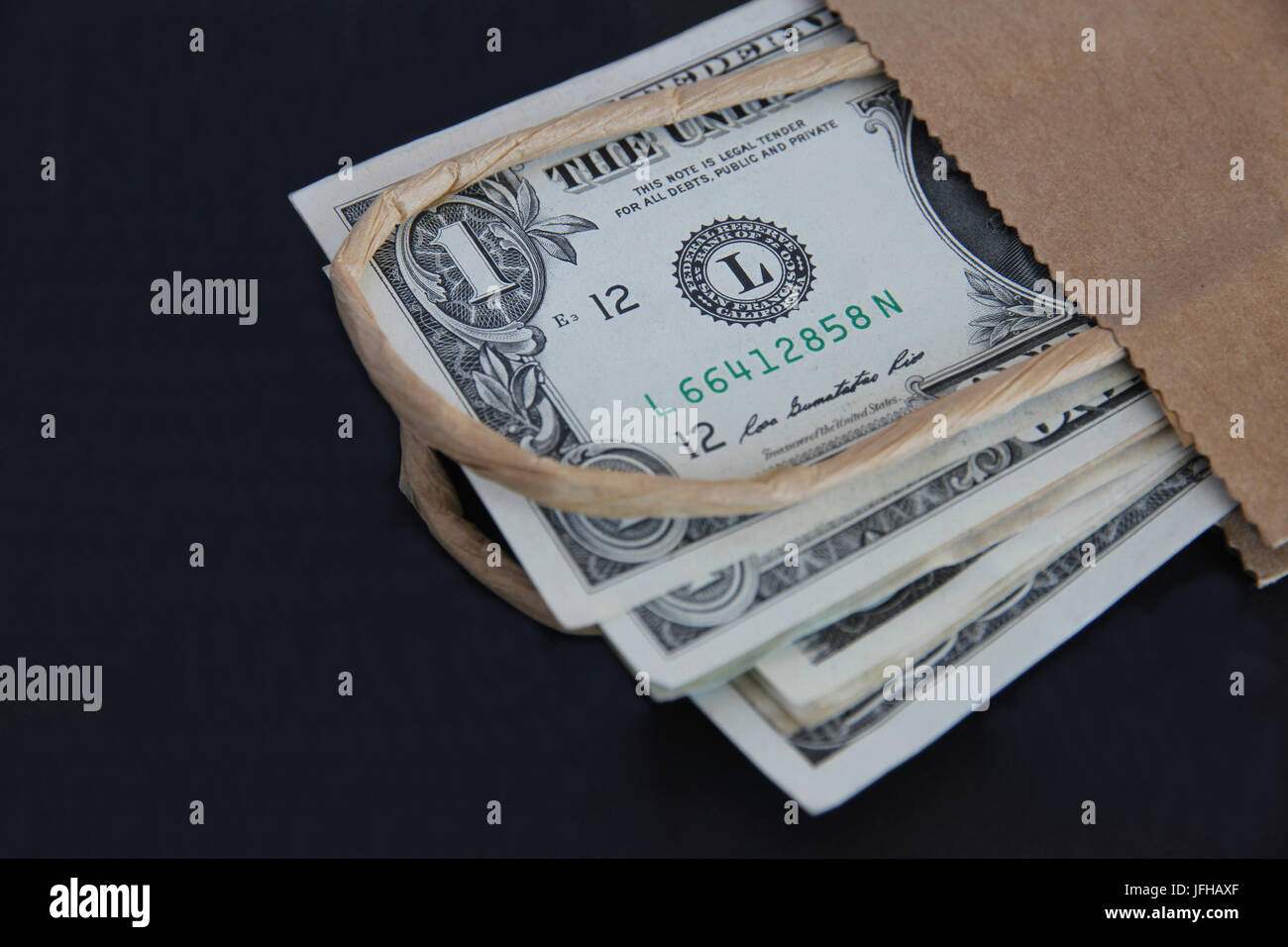American dollars in a brown paper bag Stock Photo - Alamy