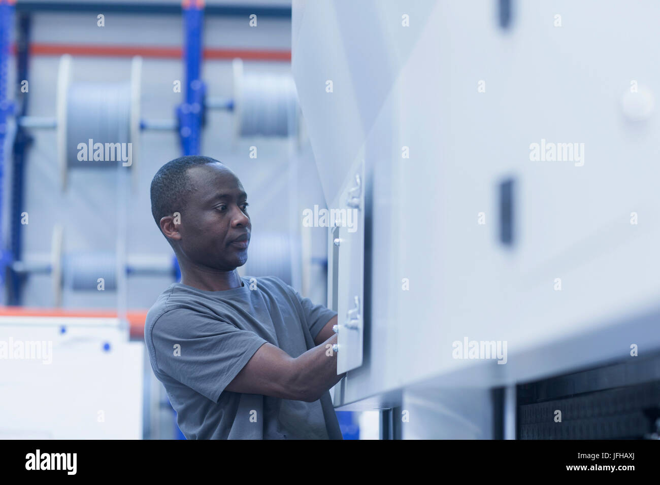 Engineer repairing machine at plant Stock Photo - Alamy