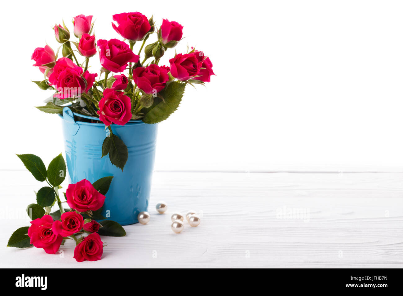 Pink Roses in a bucket Stock Photo - Alamy