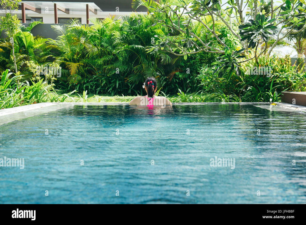Woman relaxing infinity pool hi-res stock photography and images - Alamy