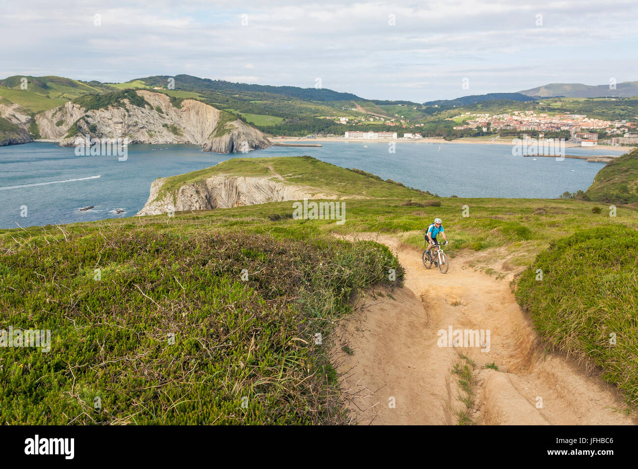 Person riding bike uphill hi-res stock photography and images - Alamy
