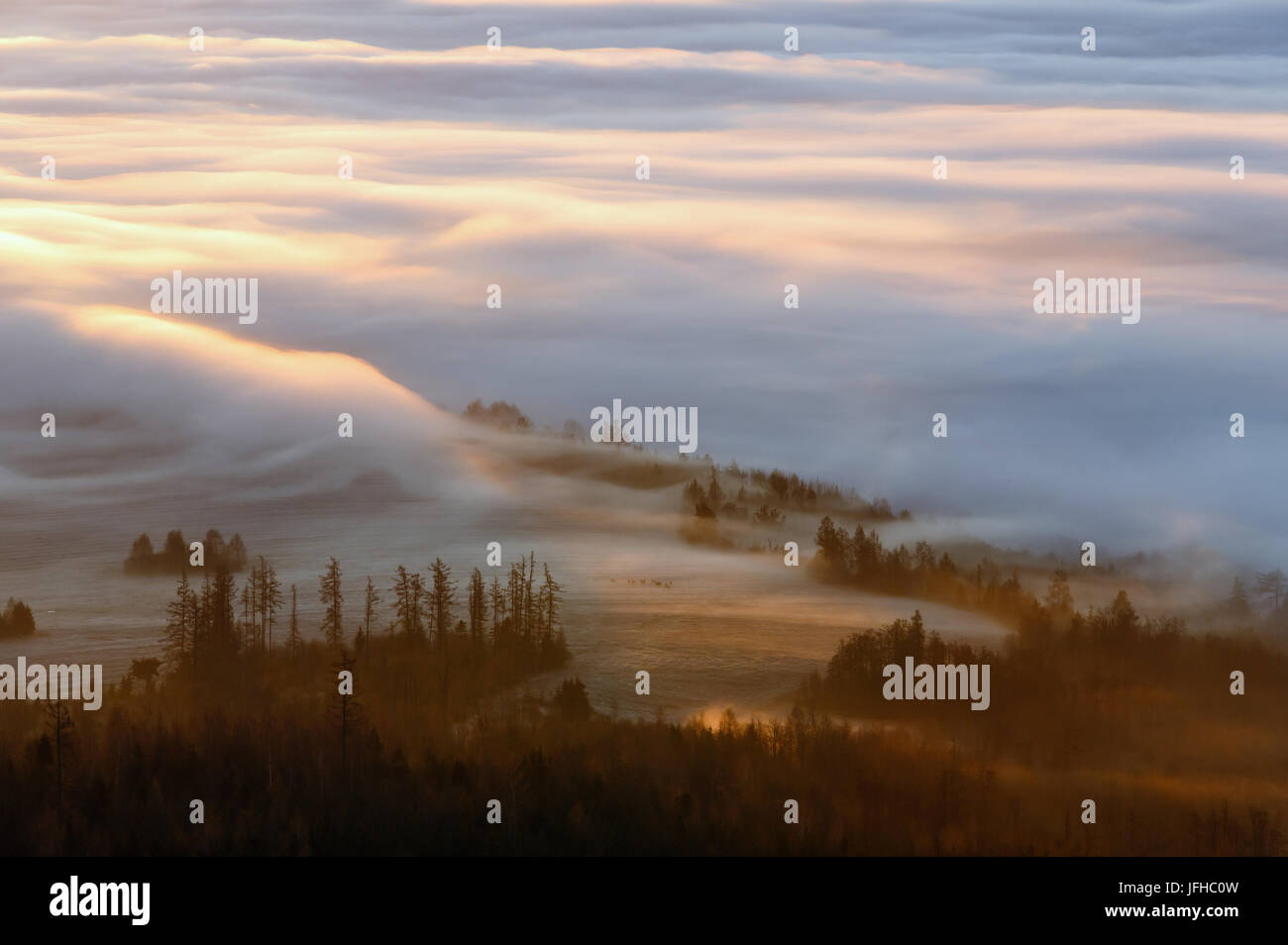 Clouds illuminated by morning sun over valley Stock Photo - Alamy
