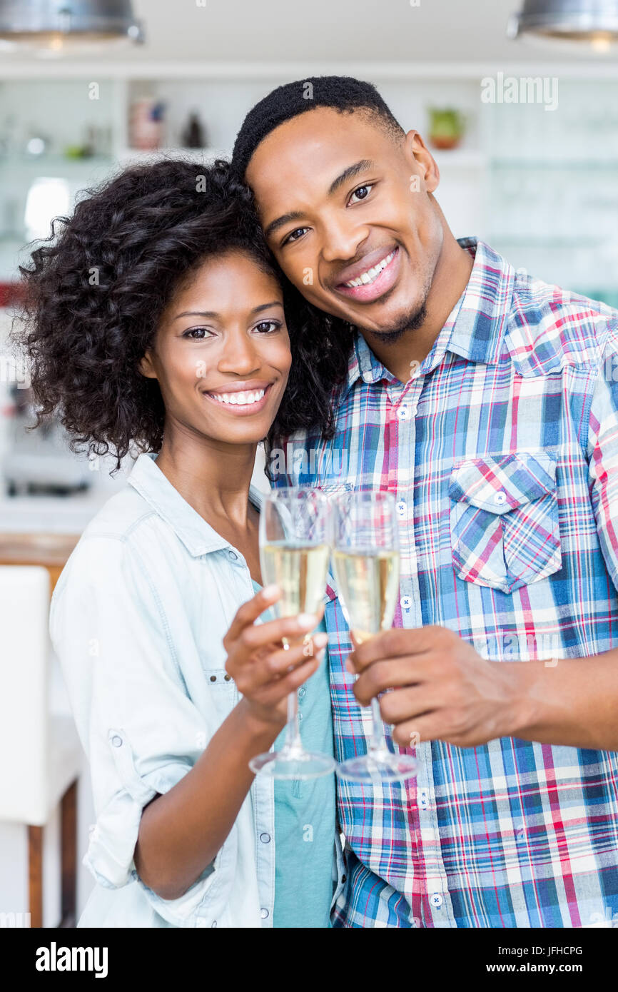Happy couple toasting champagne glass in kitchen Stock Photo - Alamy