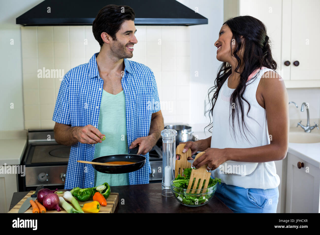 Young couple cooking food together in kitchen Stock Photo - Alamy