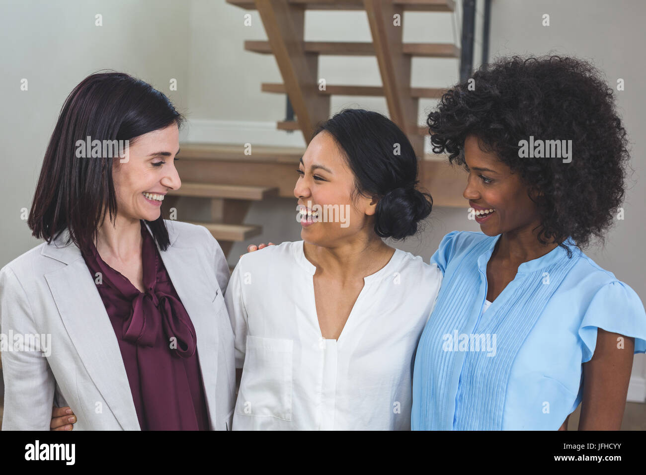 Happy female business colleagues standing together Stock Photo - Alamy