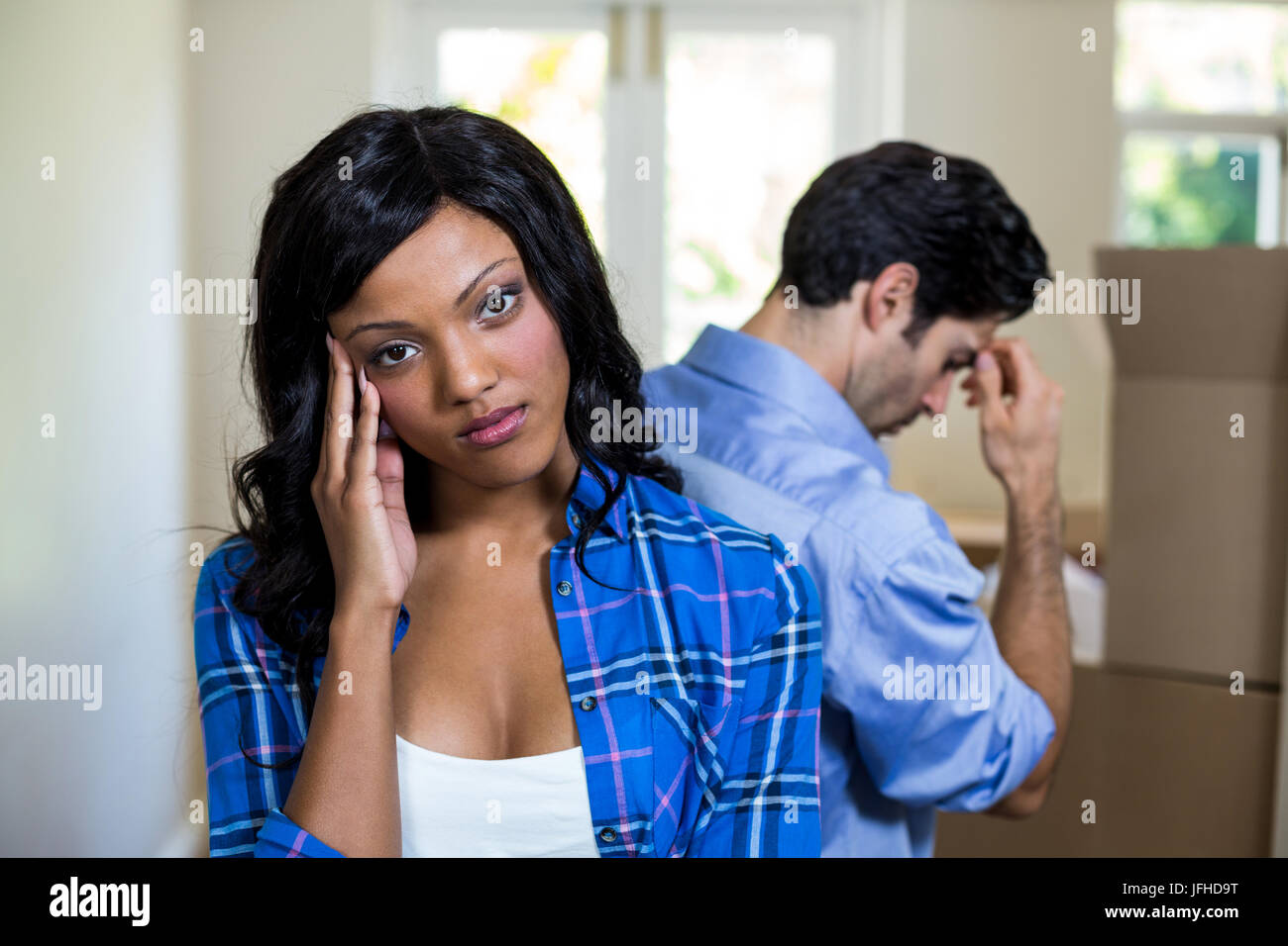 Young couple standing back to back and ignoring each other Stock Photo ...