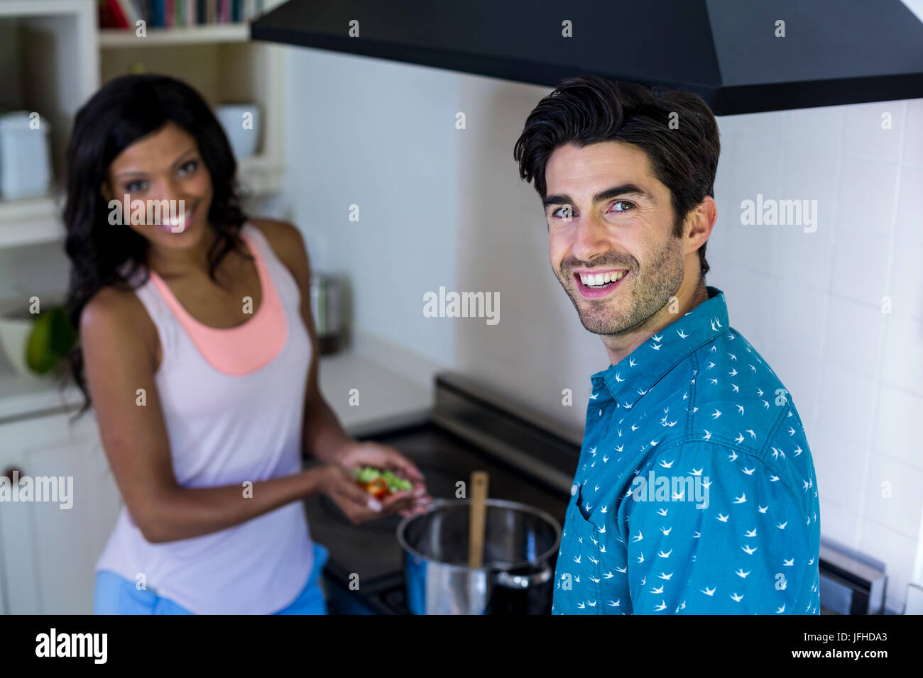 Portrait of couple cooking food together in kitchen Stock Photo - Alamy