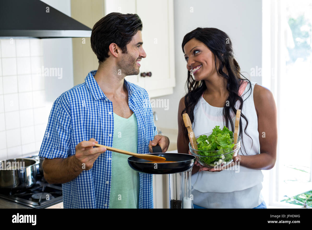 Young couple cooking food together in kitchen Stock Photo - Alamy