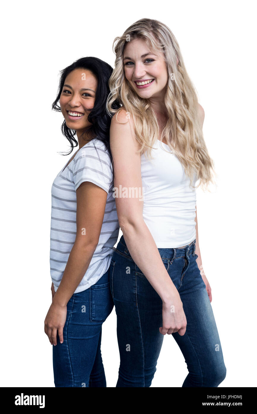 Portrait of beautiful women standing back to back Stock Photo - Alamy