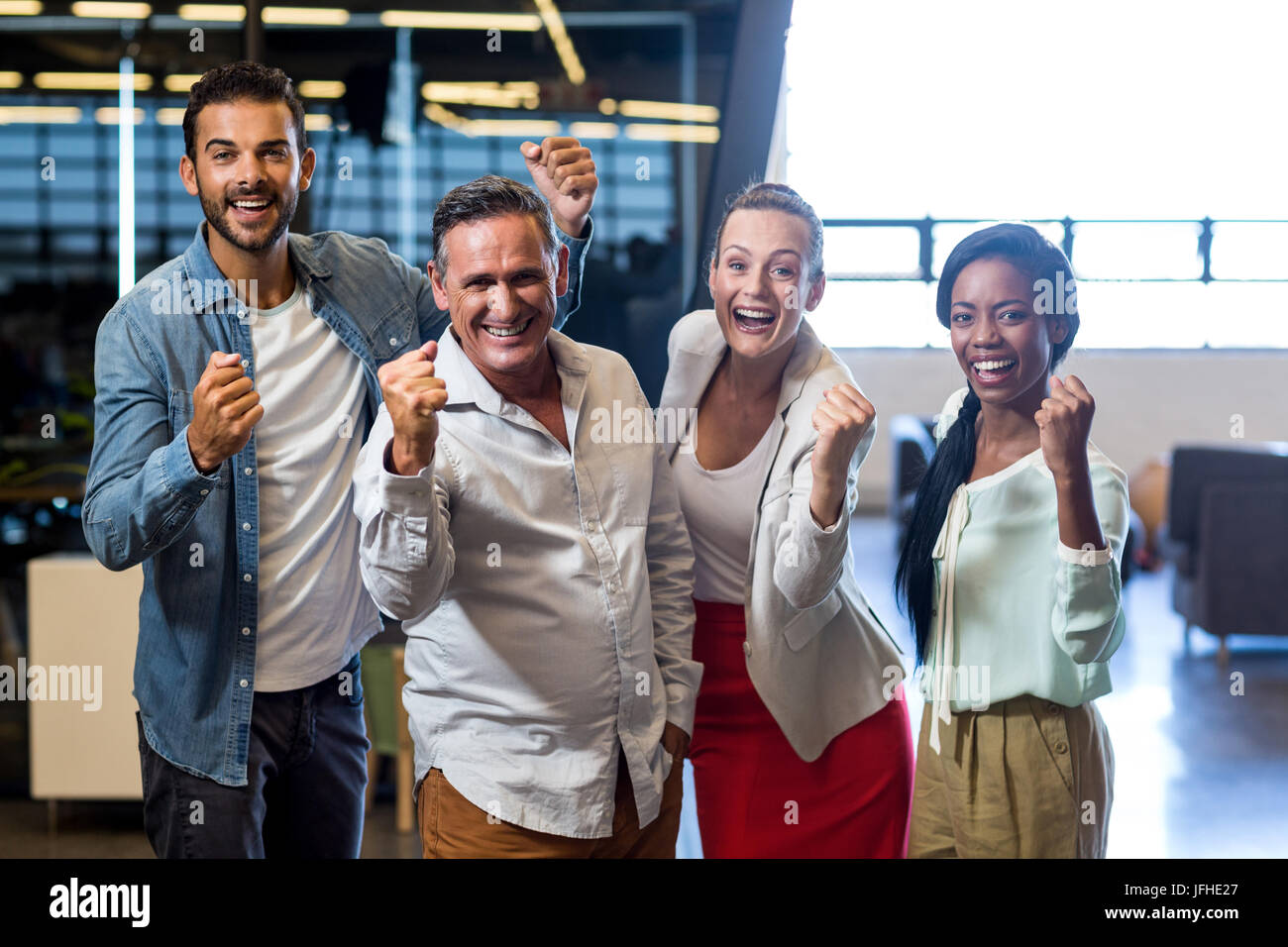 Business colleagues cheering with clenched fist Stock Photo - Alamy