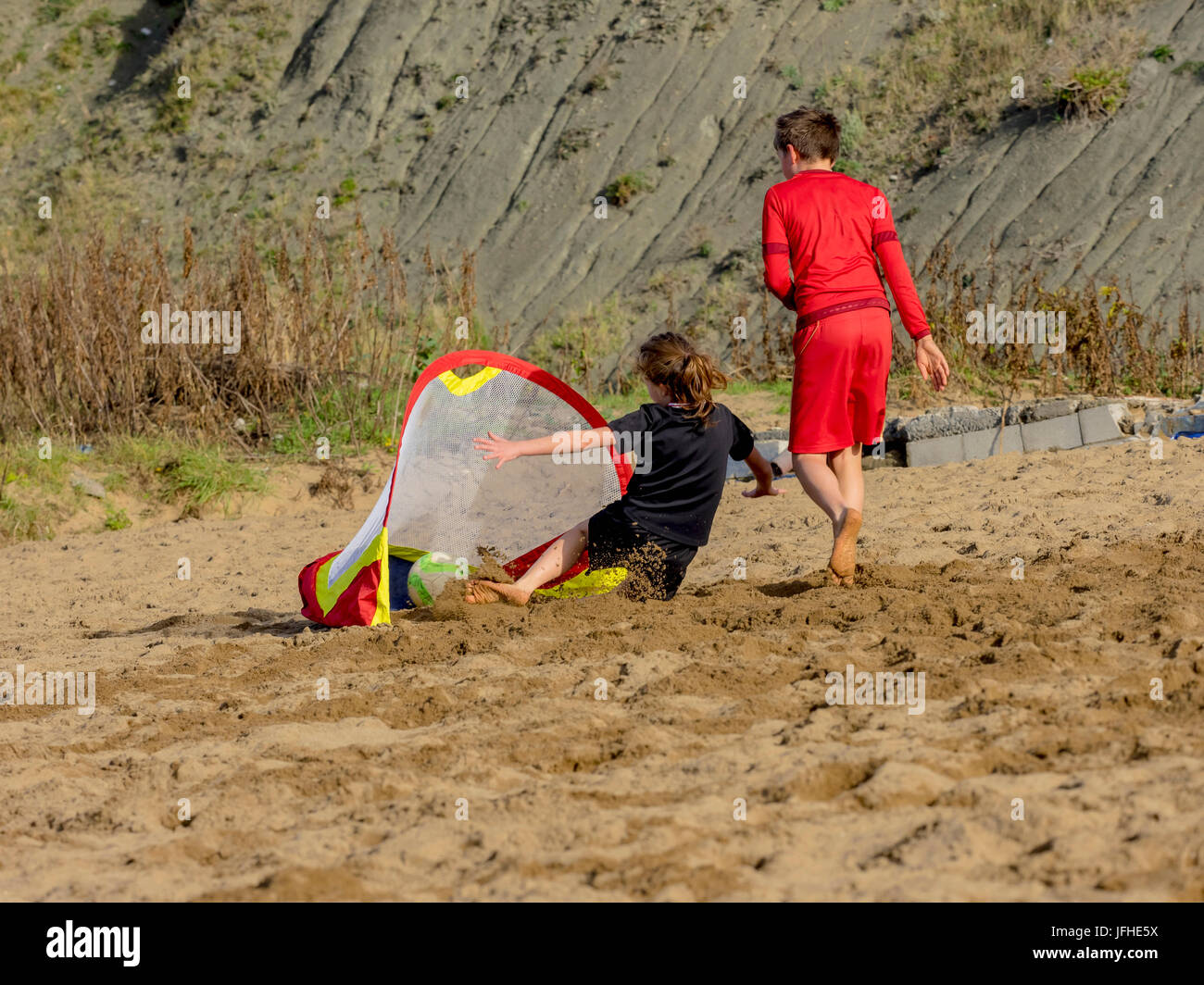 Girl kicking ball 9 hi-res stock photography and images - Alamy