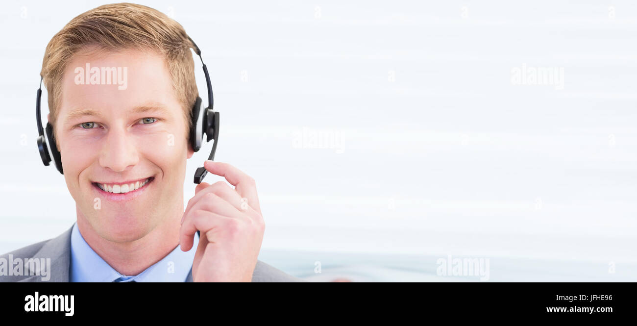 Composite image of handsome agent wearing headset Stock Photo - Alamy