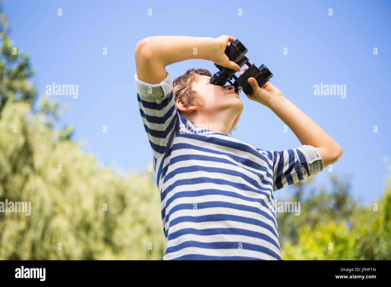 Low angle view of a child looking something with binoculars Stock Photo ...