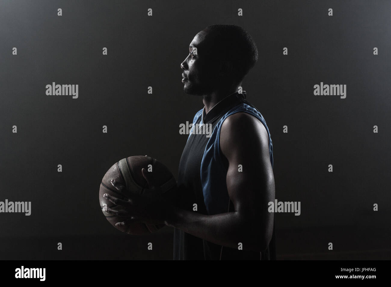 One side of a basketball player holding a basketball Stock Photo - Alamy