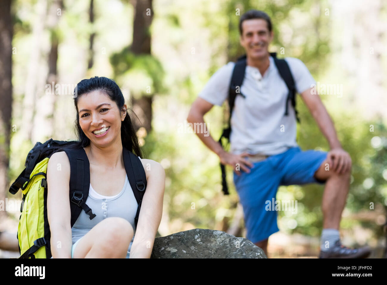 Couple smiling and posing with their backpack Stock Photo - Alamy