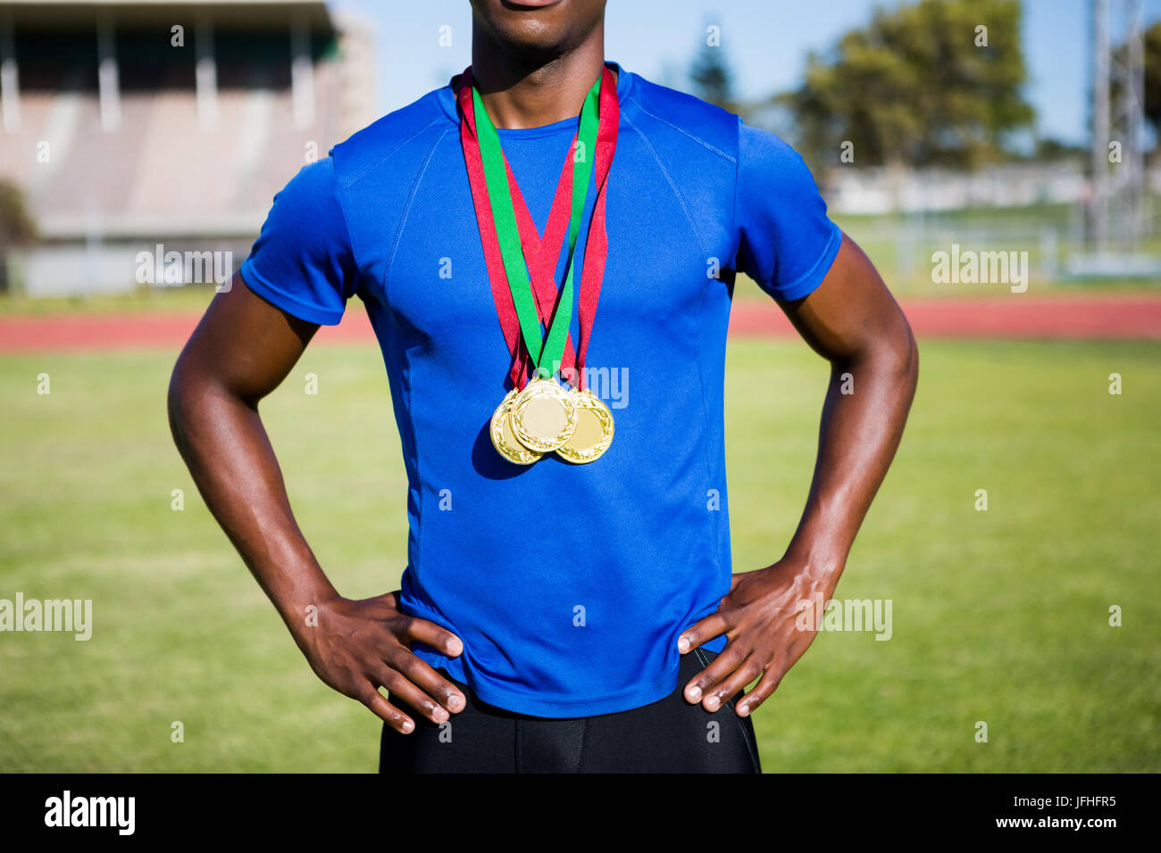 Athlete posing with gold medals after victory Stock Photo - Alamy