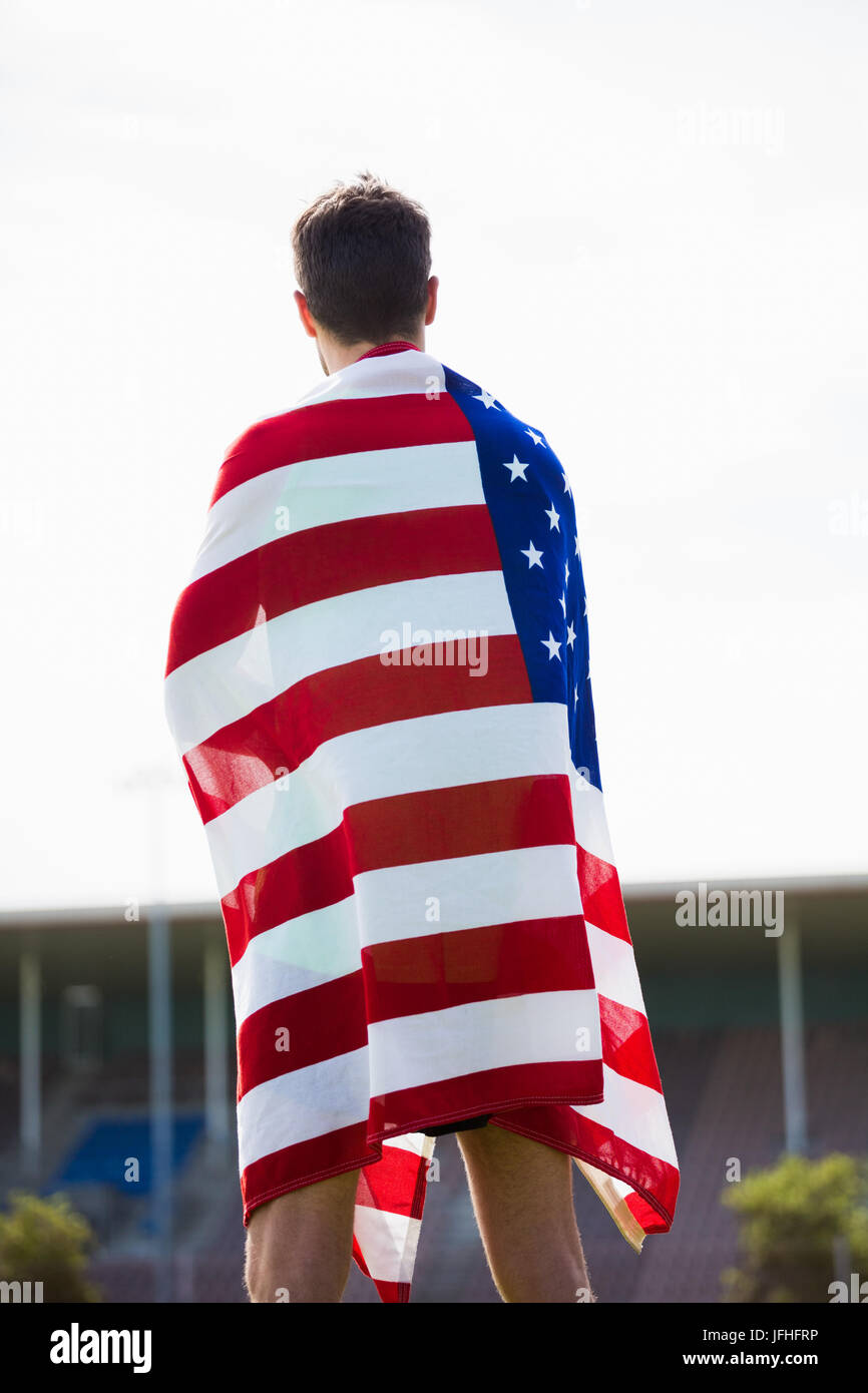 Athlete with american flag wrapped around his body Stock Photo - Alamy