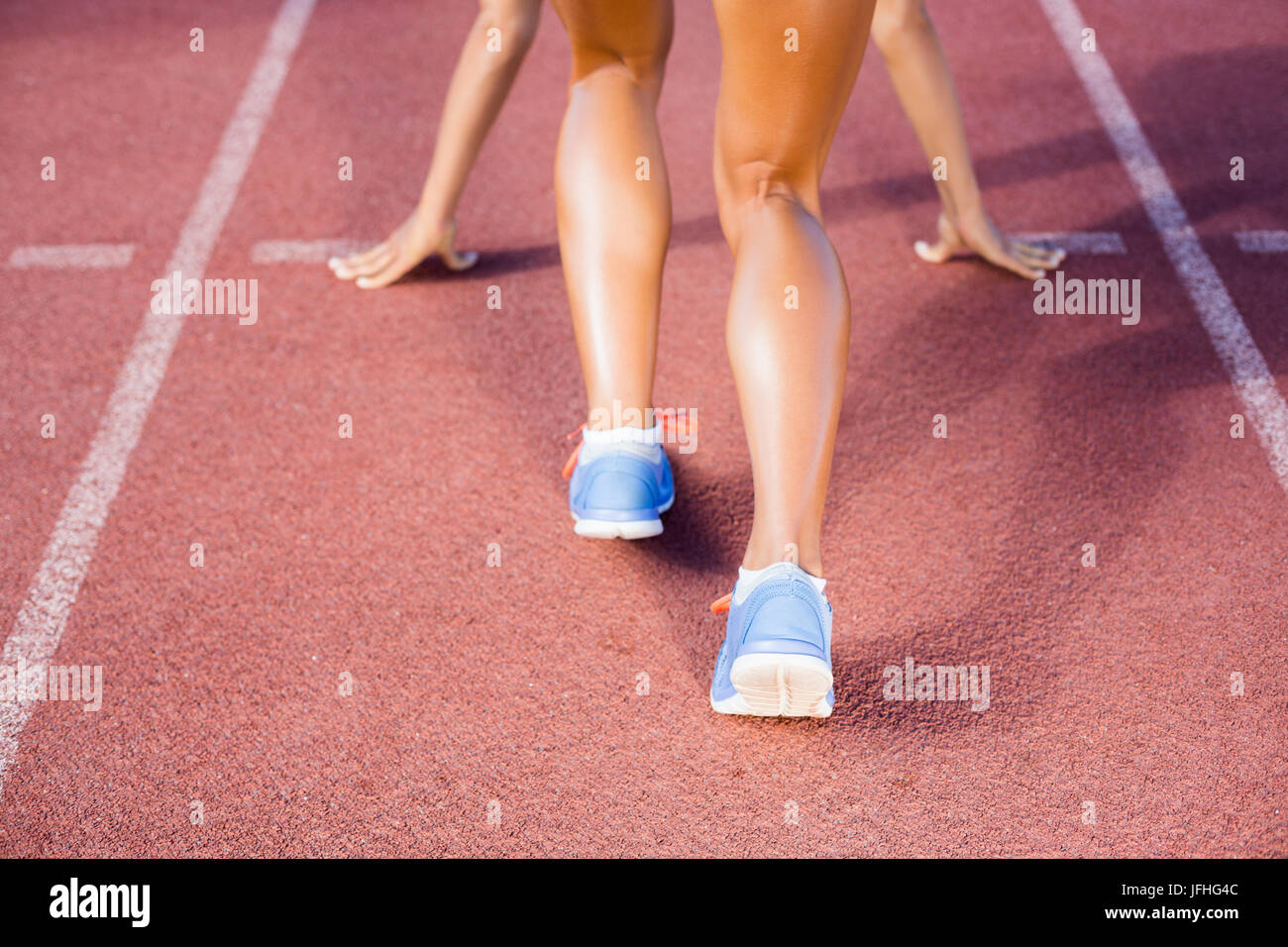 Female athlete ready to run on running track Stock Photo - Alamy