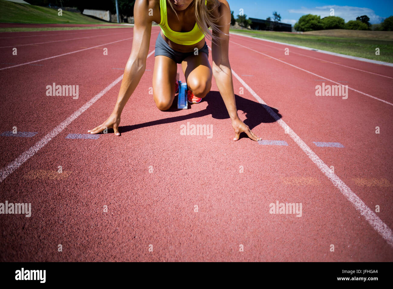 Female athlete ready to run on running track Stock Photo - Alamy