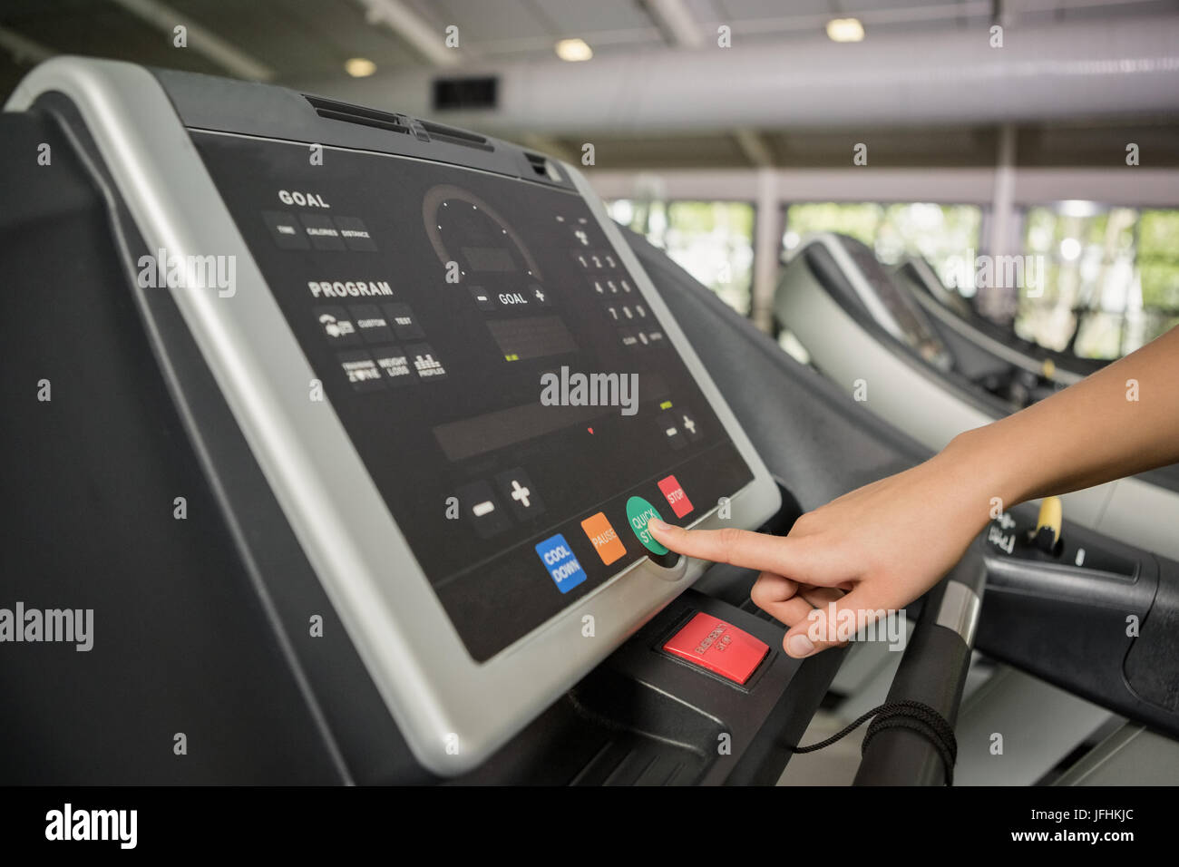Hand of a person setting control panel of treadmill Stock Photo - Alamy