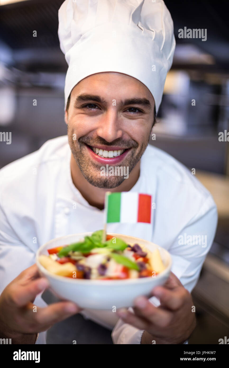 Handsome chef presenting meal with italian flag Stock Photo - Alamy