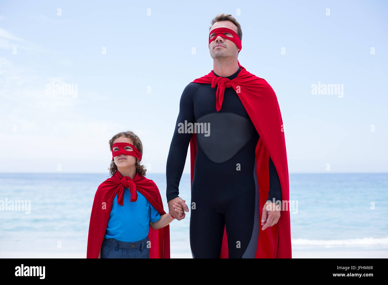 Father and daughter in superhero costume sea shore Stock Photo - Alamy