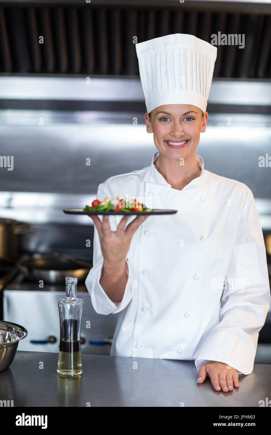 Portrait of smiling female chef holding food plate Stock Photo - Alamy