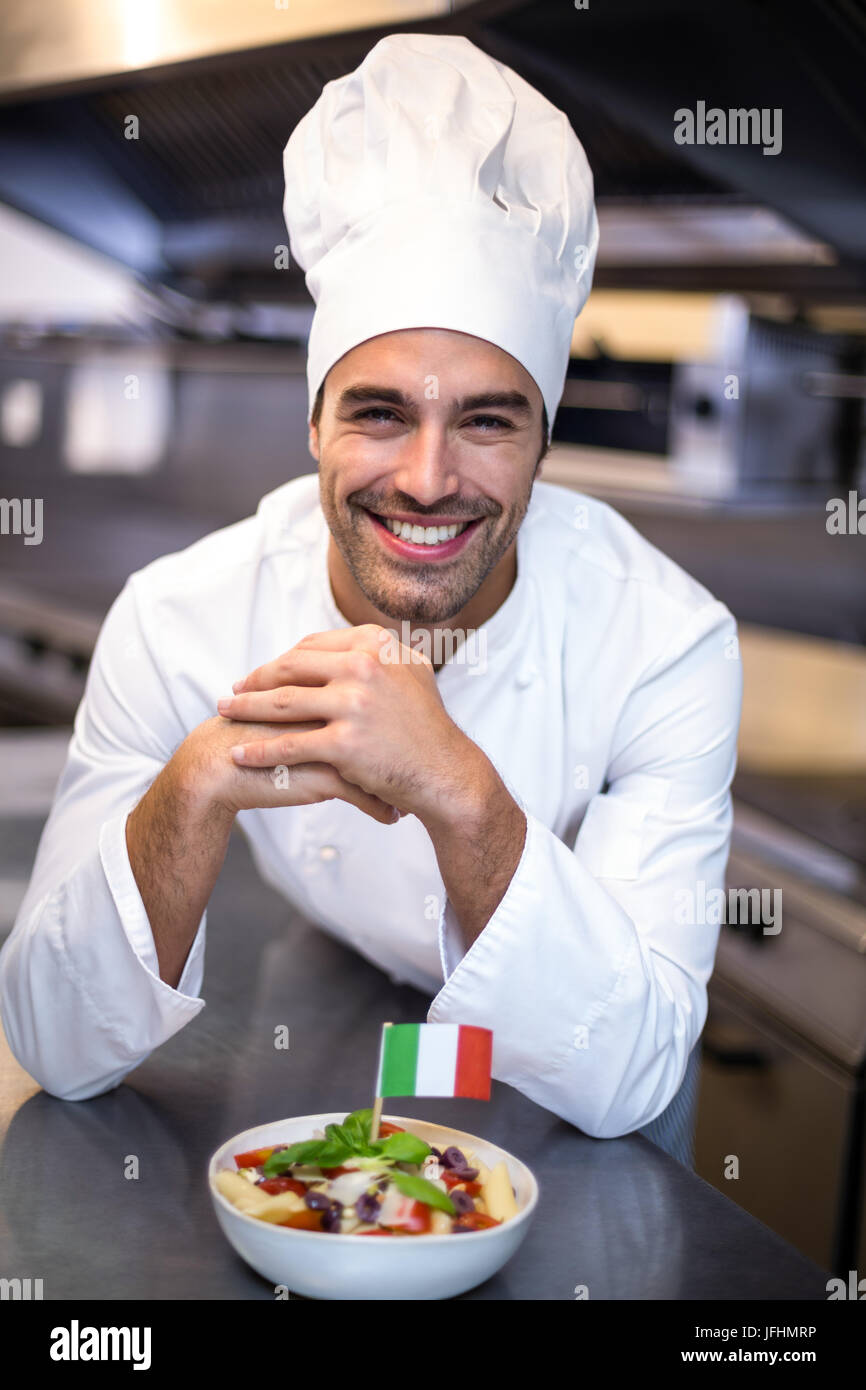 Handsome chef presenting meal with italian flag Stock Photo - Alamy