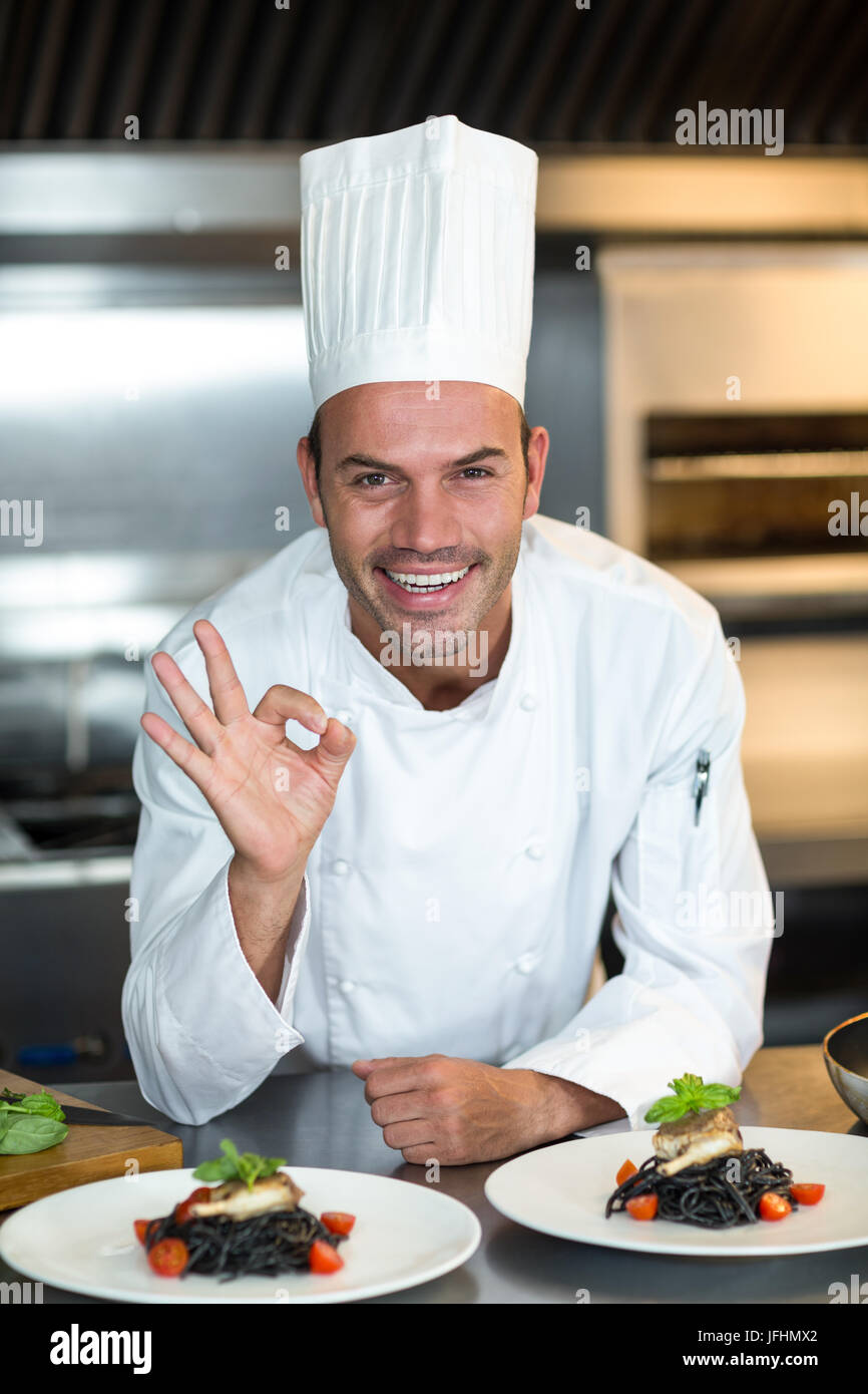Portrait of chef gesturing in a commercial kitchen Stock Photo - Alamy