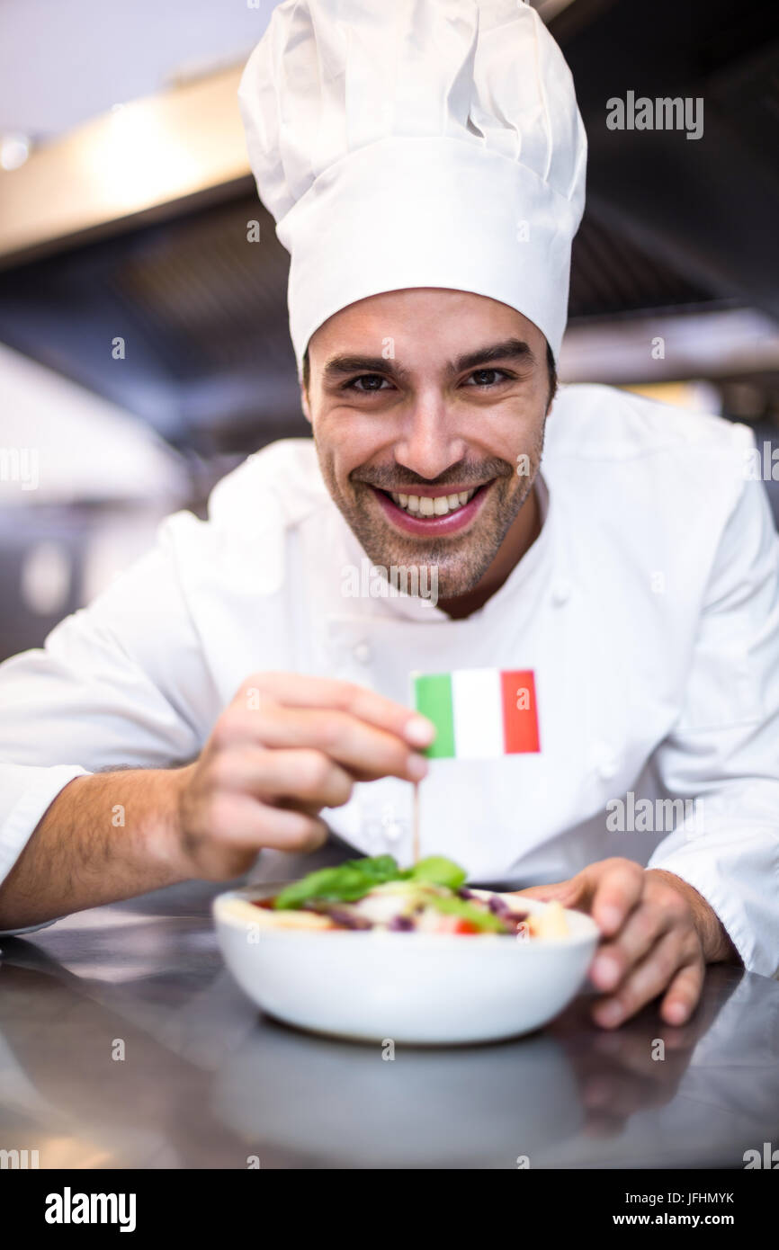 Handsome chef presenting meal with italian flag Stock Photo - Alamy