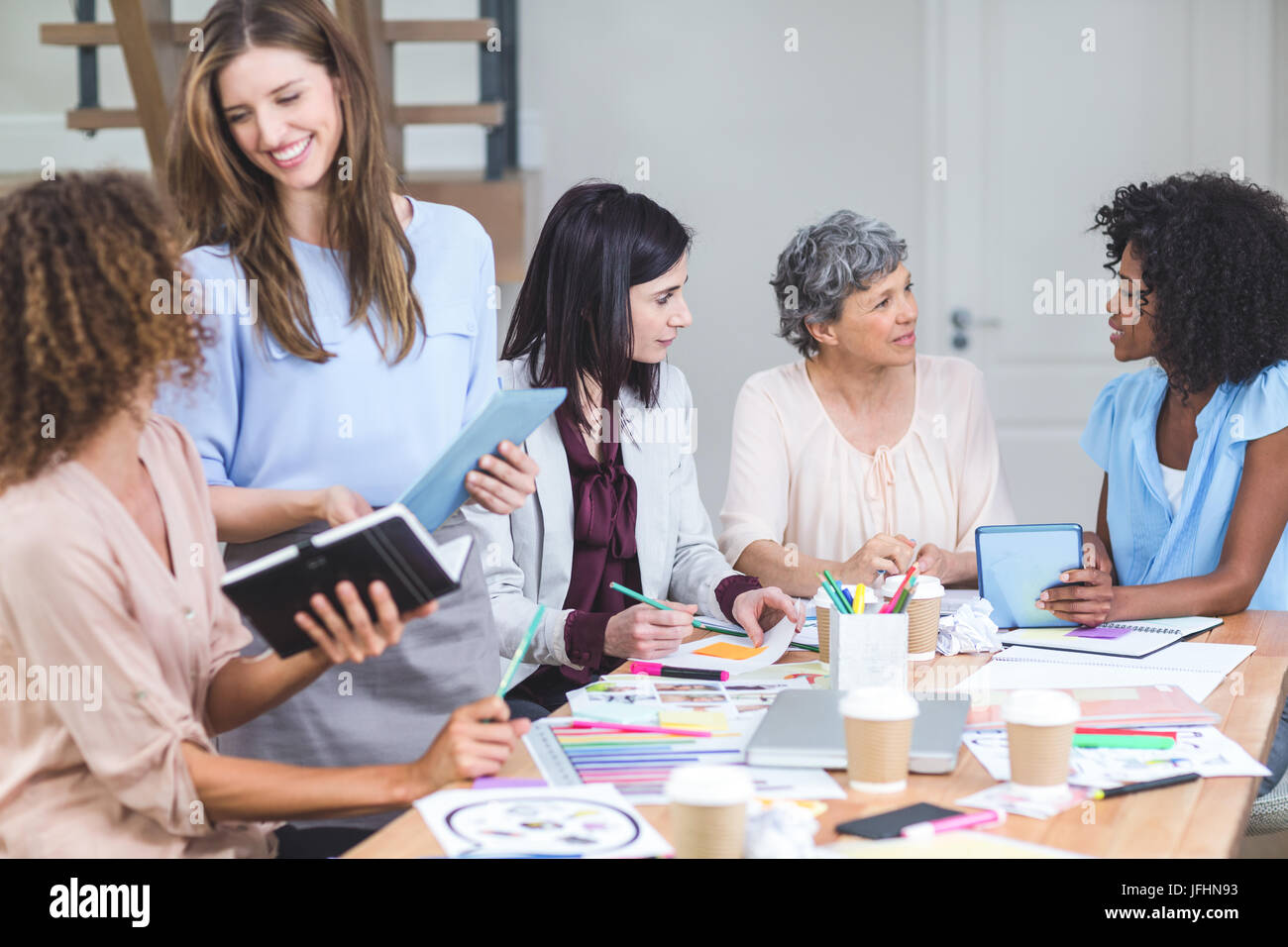 Group of interior designers interacting with each other Stock Photo - Alamy