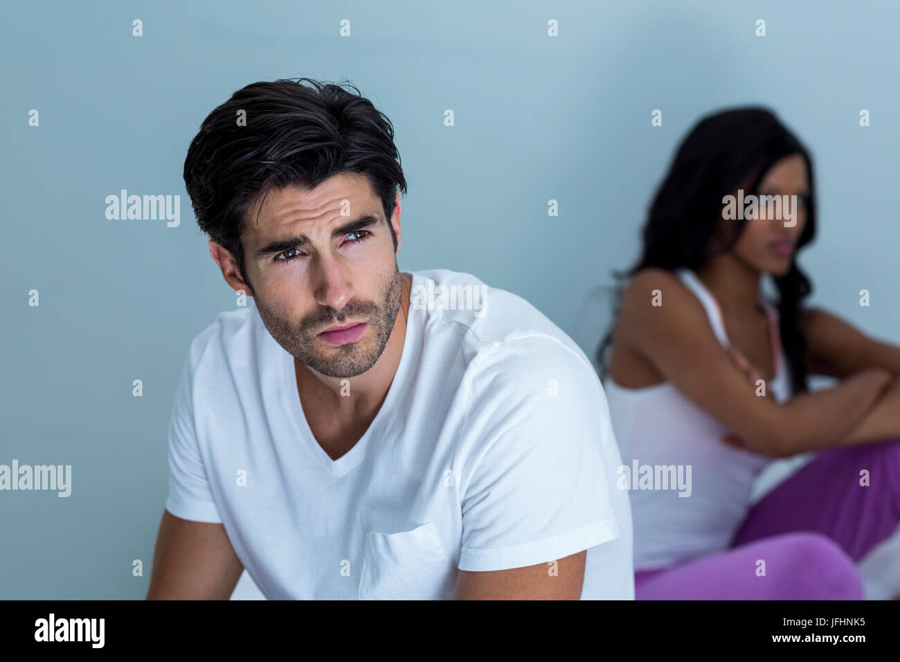 Upset couple ignoring each other after fight on bed Stock Photo - Alamy