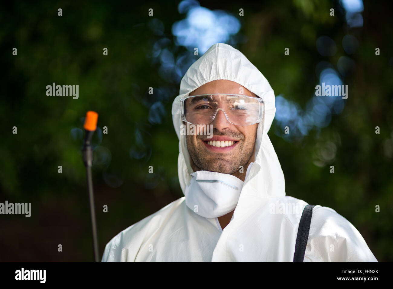 Close-up portrait of smiling man with pesticide sprayer Stock Photo - Alamy