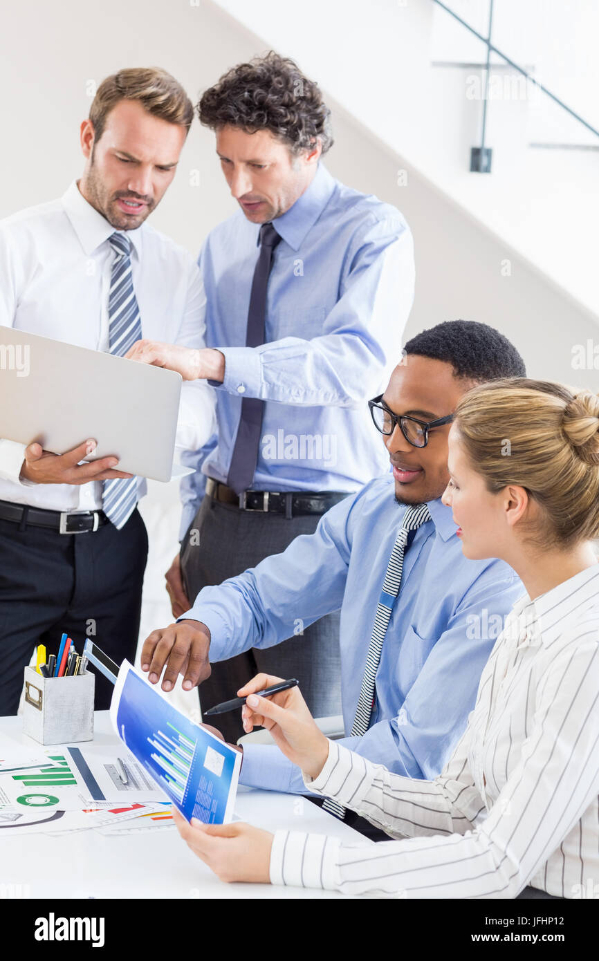 Business colleagues reviewing a report at desk Stock Photo - Alamy