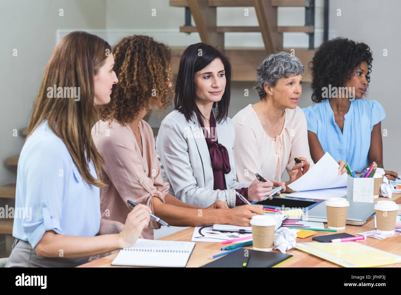 Group of interior designers listening to presentation Stock Photo - Alamy